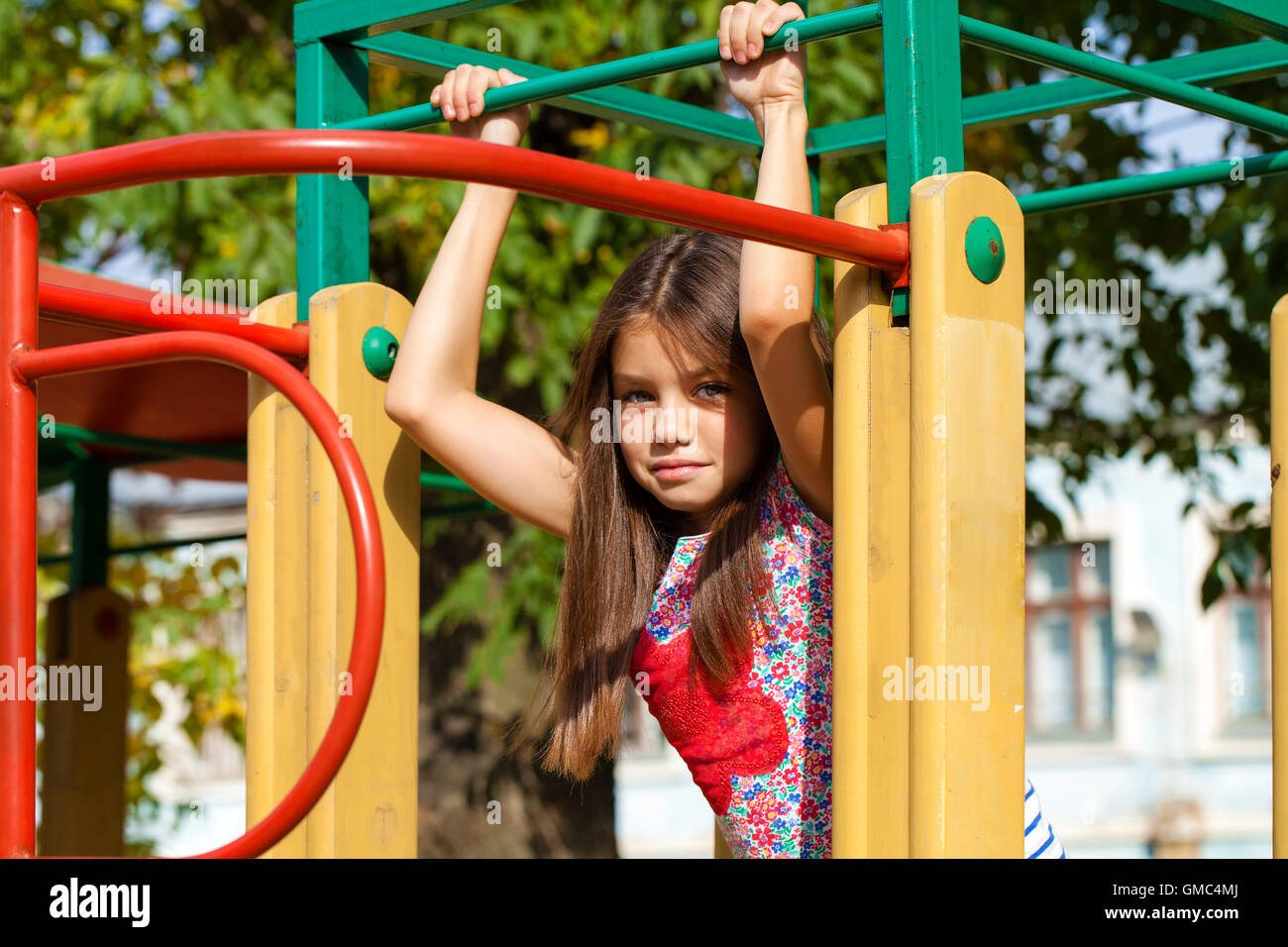 Cose up, Beautiful little girl on green background of summer city park ...