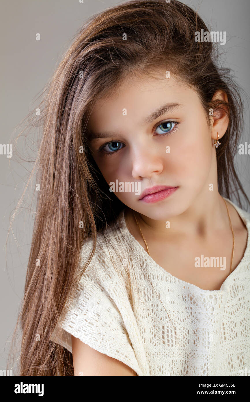 Portrait of a charming brunette little girl, isolated on gray background Stock Photo - Alamy