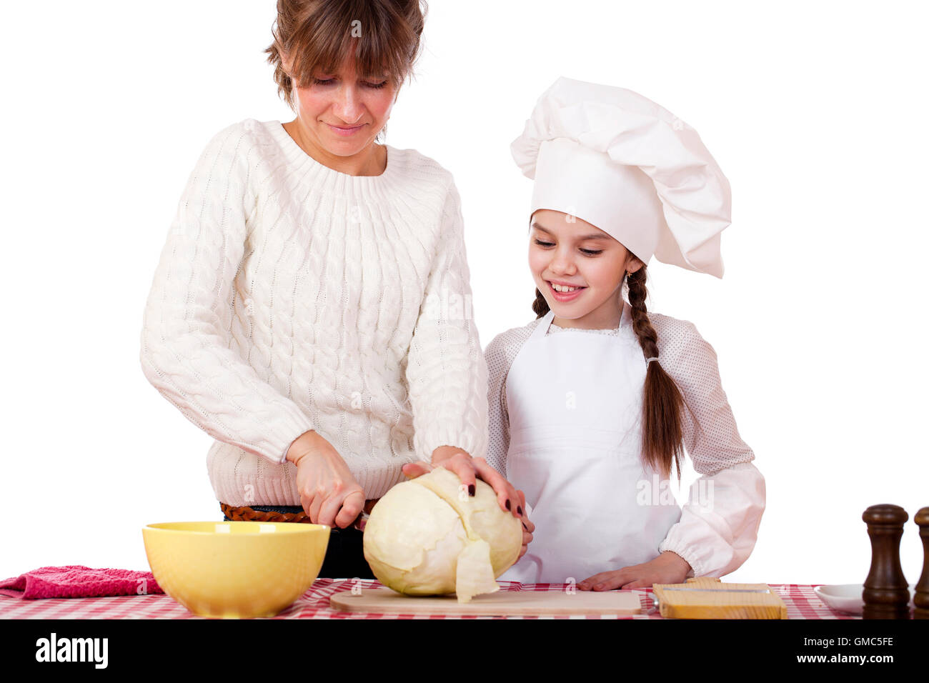 Cooking and people concept - Little girl in cook hat and mother ...