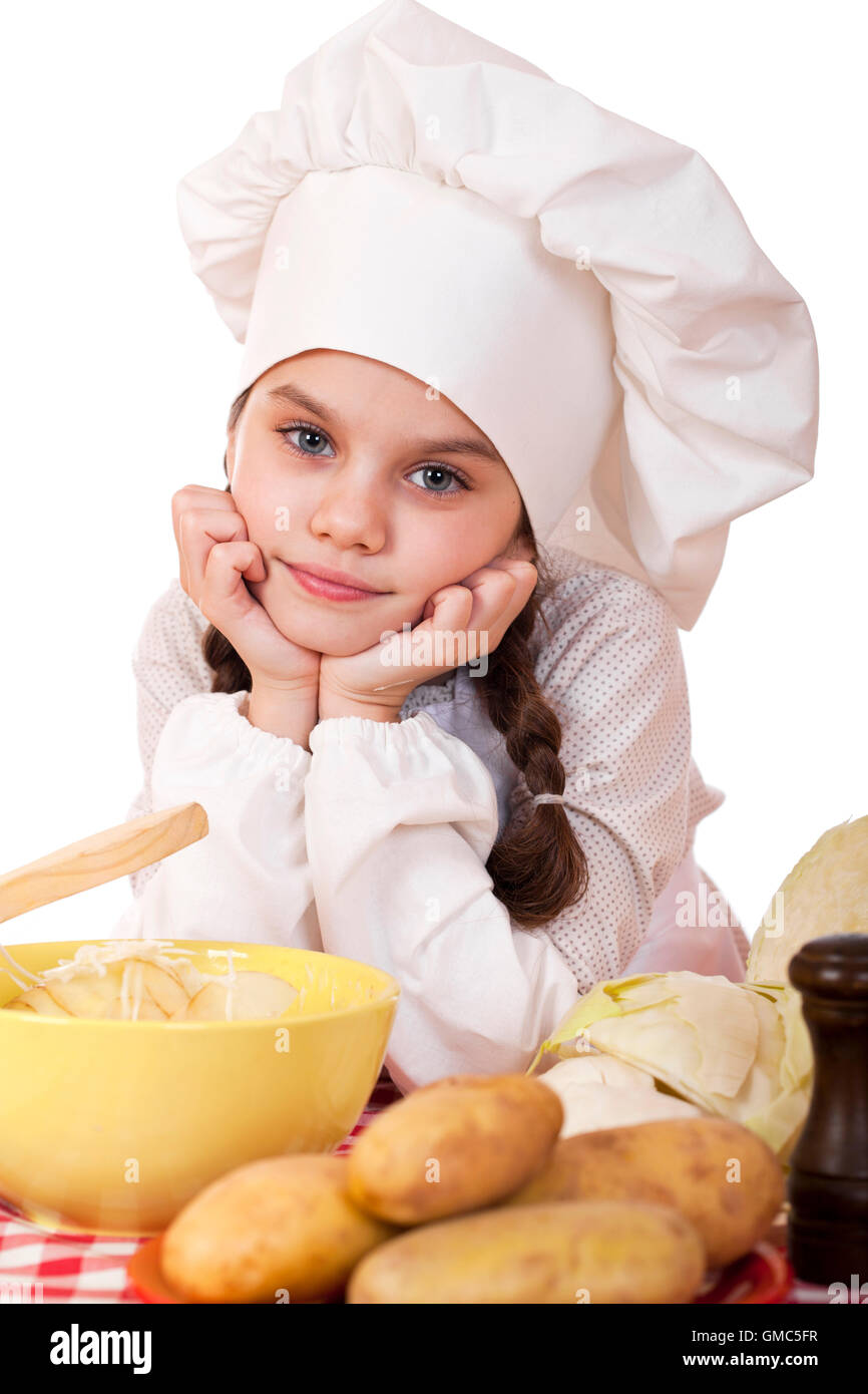 Beautiful little chief cooker on the desk with vegetables, isolated on ...