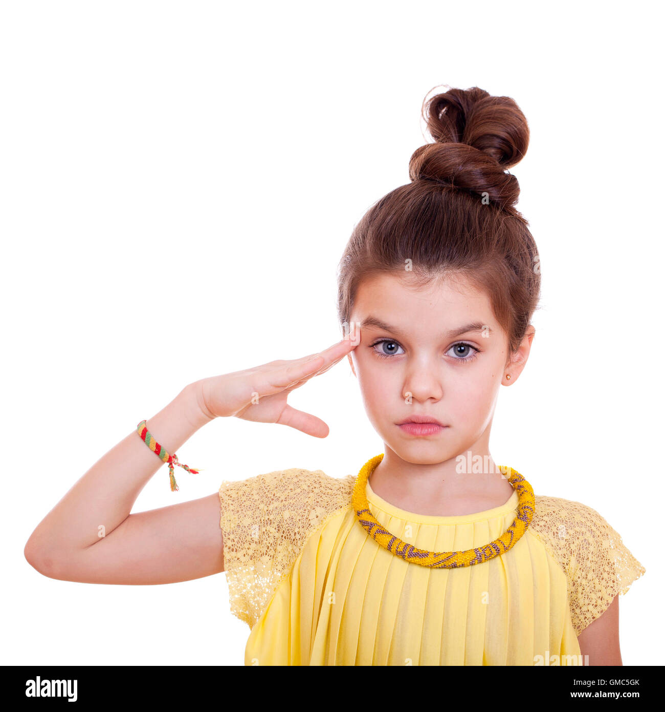 Teenager salutes, his hand on his head, studio on white background ...
