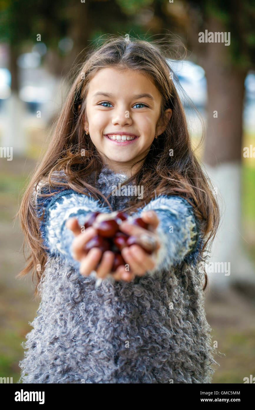 Close up portrait of a beautiful nine year old little girl in autumn ...