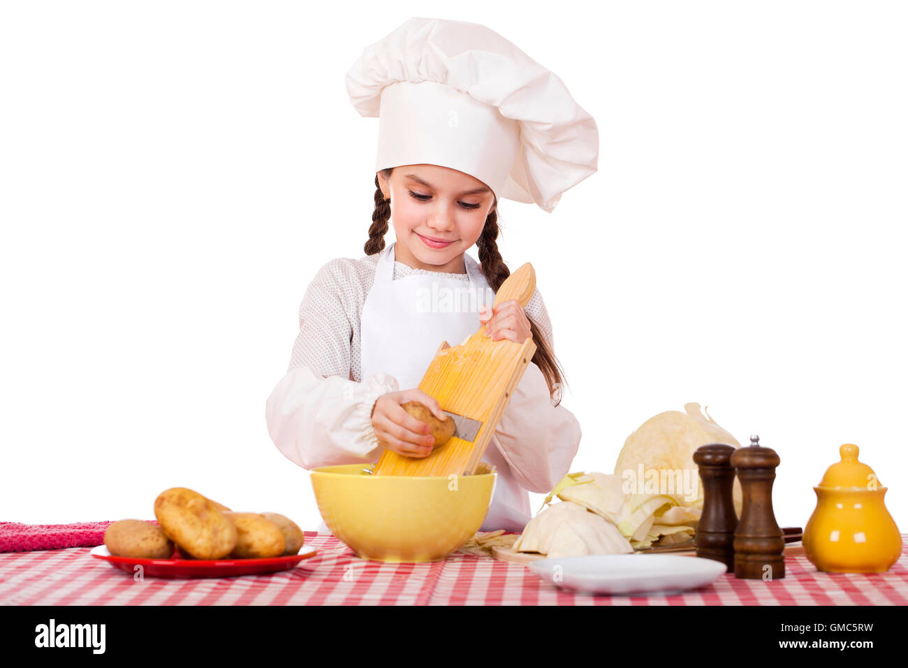 Beautiful little chief cooker on the desk with vegetables, isolated on ...