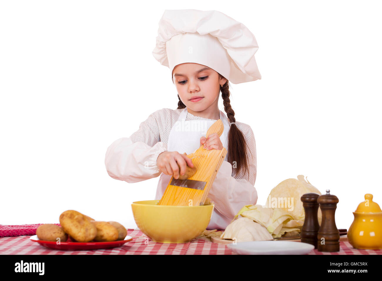 Beautiful little chief cooker on the desk with vegetables, isolated on ...