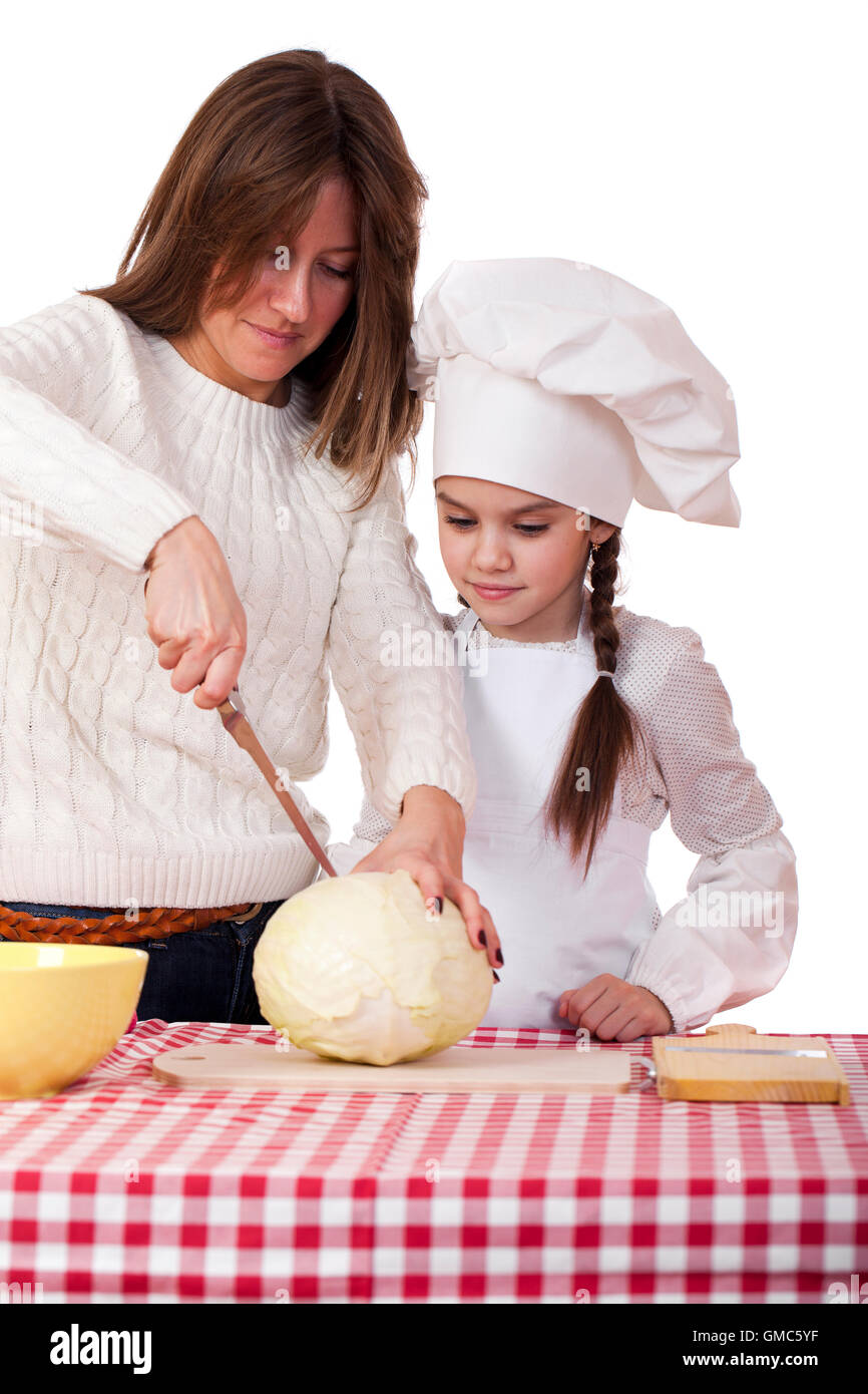 Cooking and people concept - Little girl in cook hat and mother ...