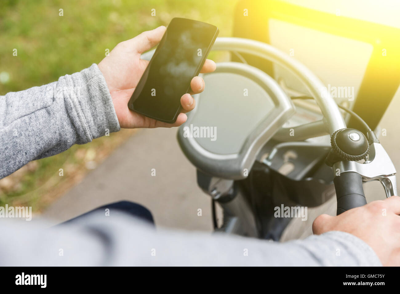 Man rides bicycle and holding black mobile phone Stock Photo - Alamy