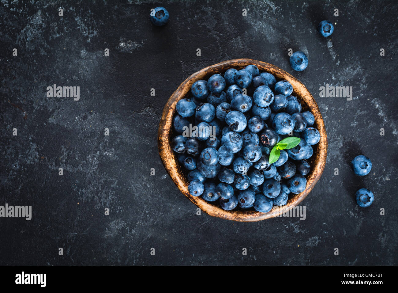 Freshly picked blueberries in a bowl on dark background, top view Stock ...