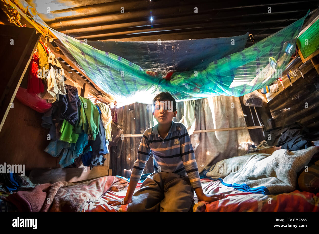 A boy inside his room at a temporary house, one year after the 2015 ...