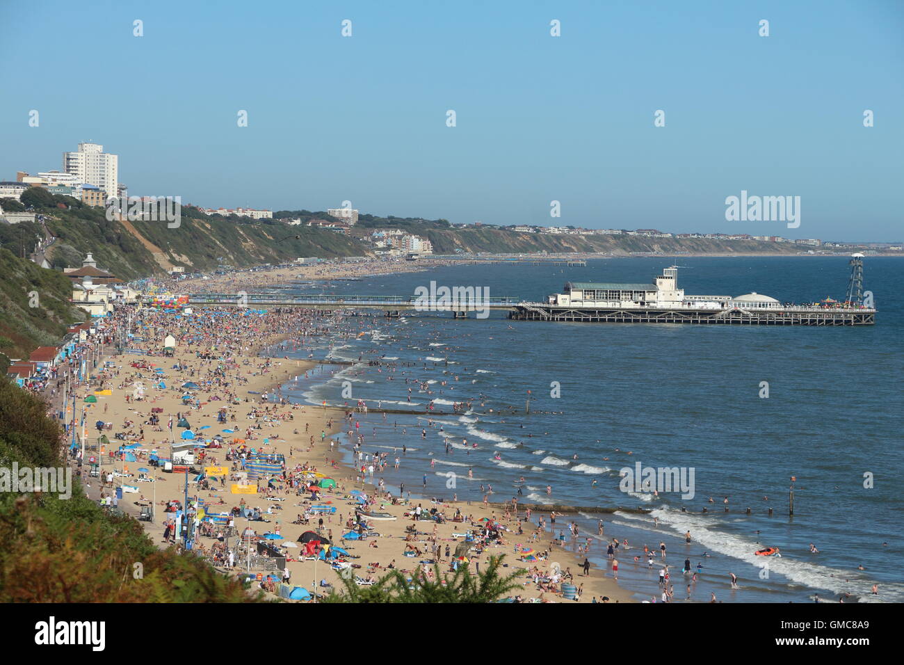 Bournemouth pier and beach on a busy sunny day with lots of holiday ...