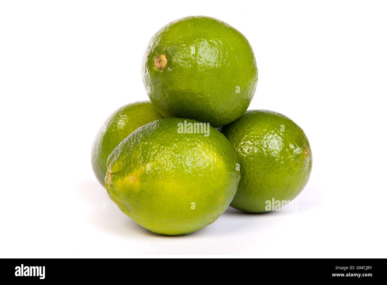 Group of whole limes and one half lime on white Stock Photo - Alamy