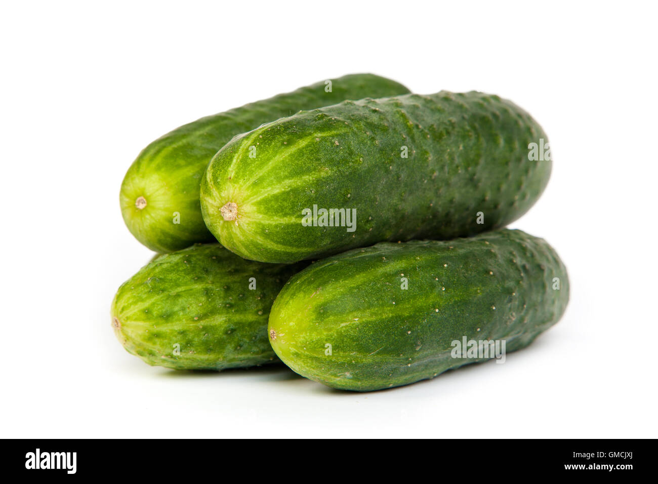 Five Fresh Cucumbers isolated on white Stock Photo - Alamy