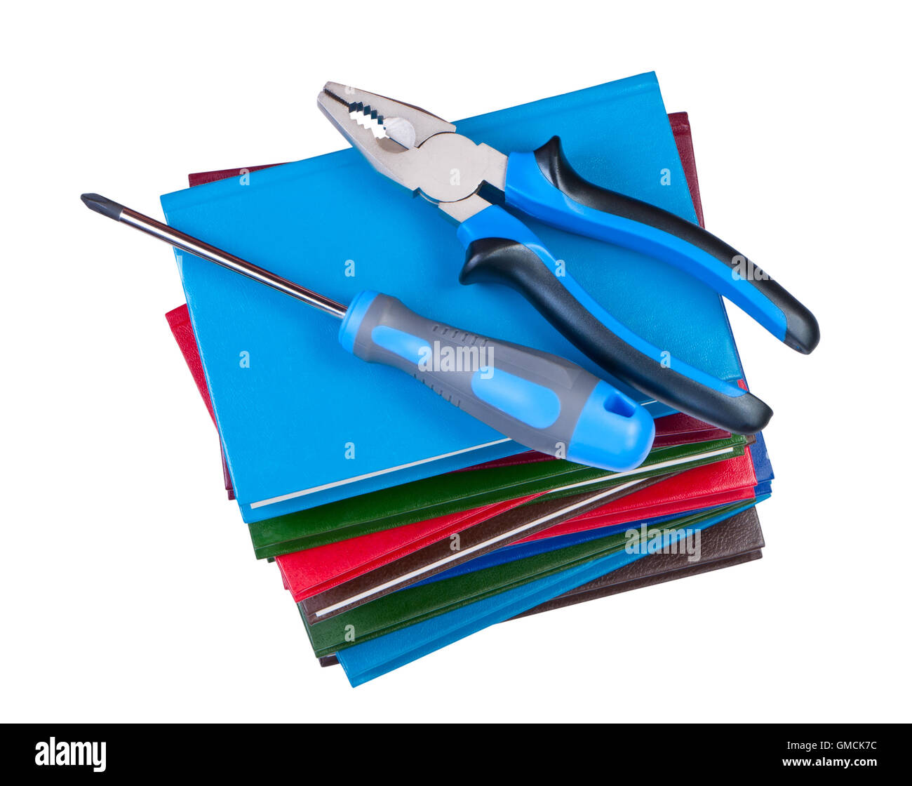Building tool, screwdriver and pliers on a stack of books Stock Photo ...