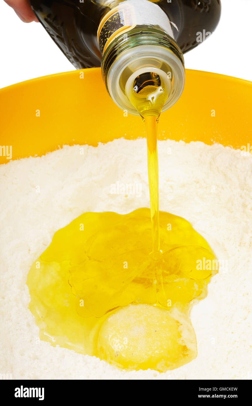 Oil flowing to the broken egg in the flour Stock Photo - Alamy
