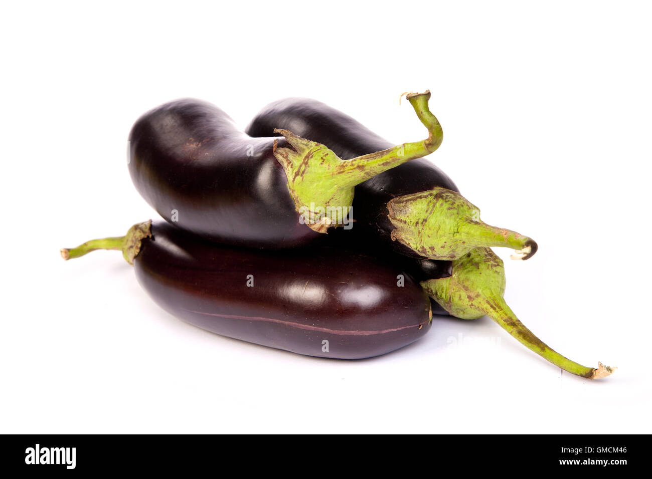 Three large eggplant, over white background Stock Photo - Alamy