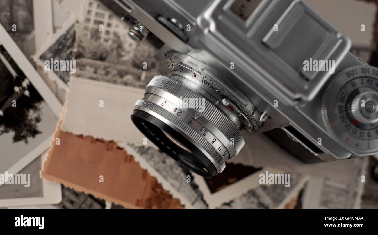 Old camera with photos close up Stock Photo - Alamy
