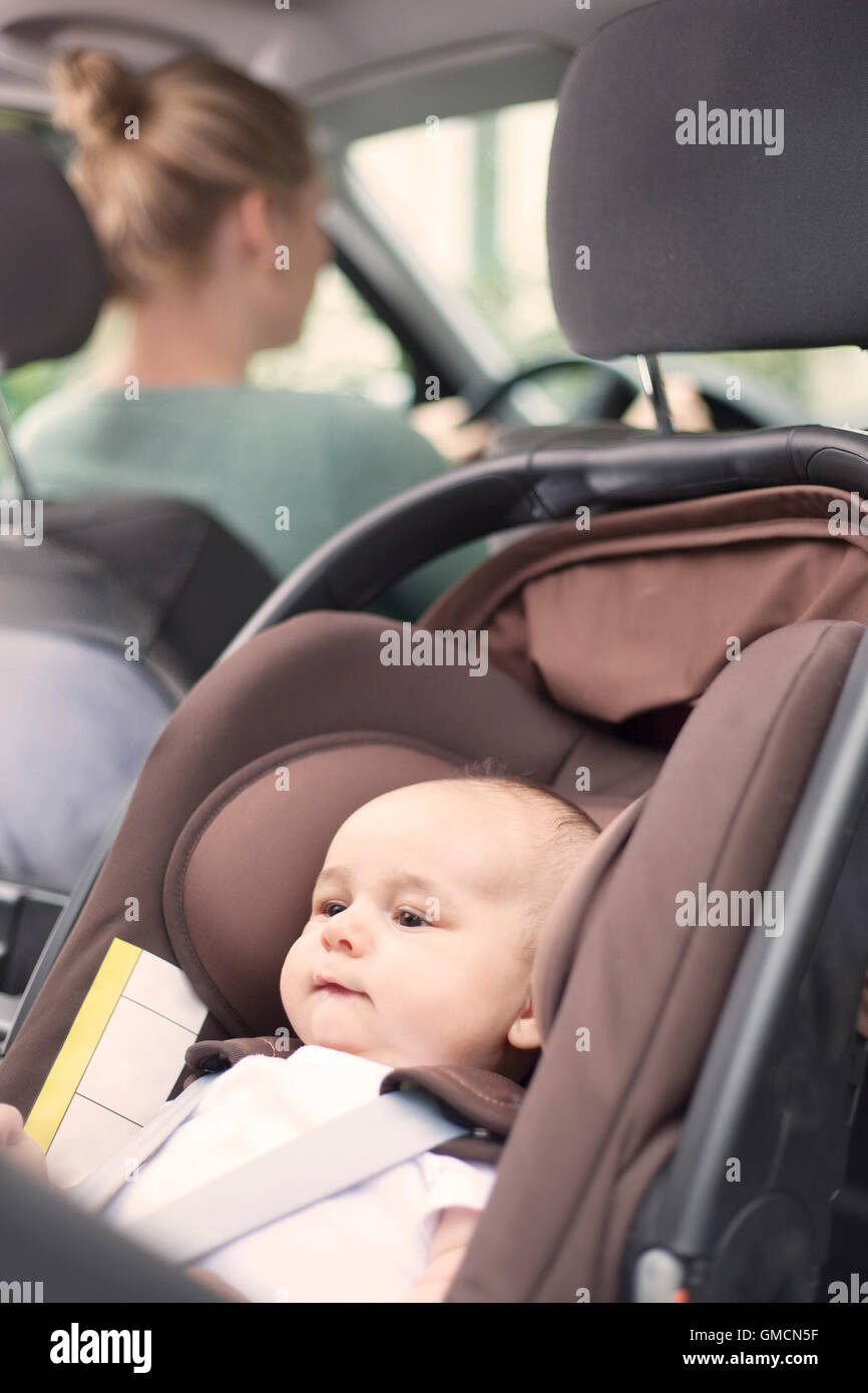 Traveling safe. Parent driving with child in the back seat Stock Photo ...