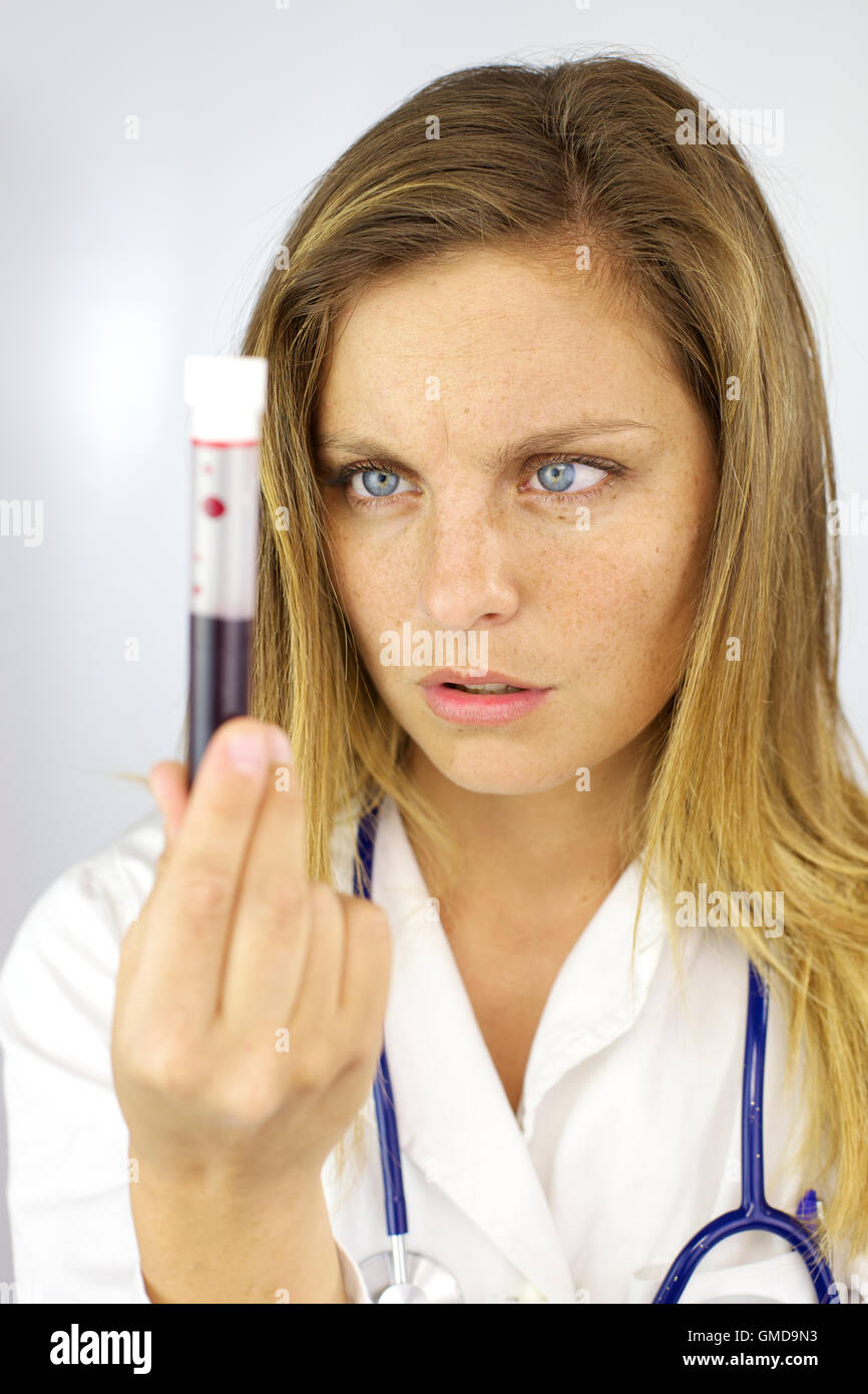 Doctor looking blood sample Stock Photo - Alamy