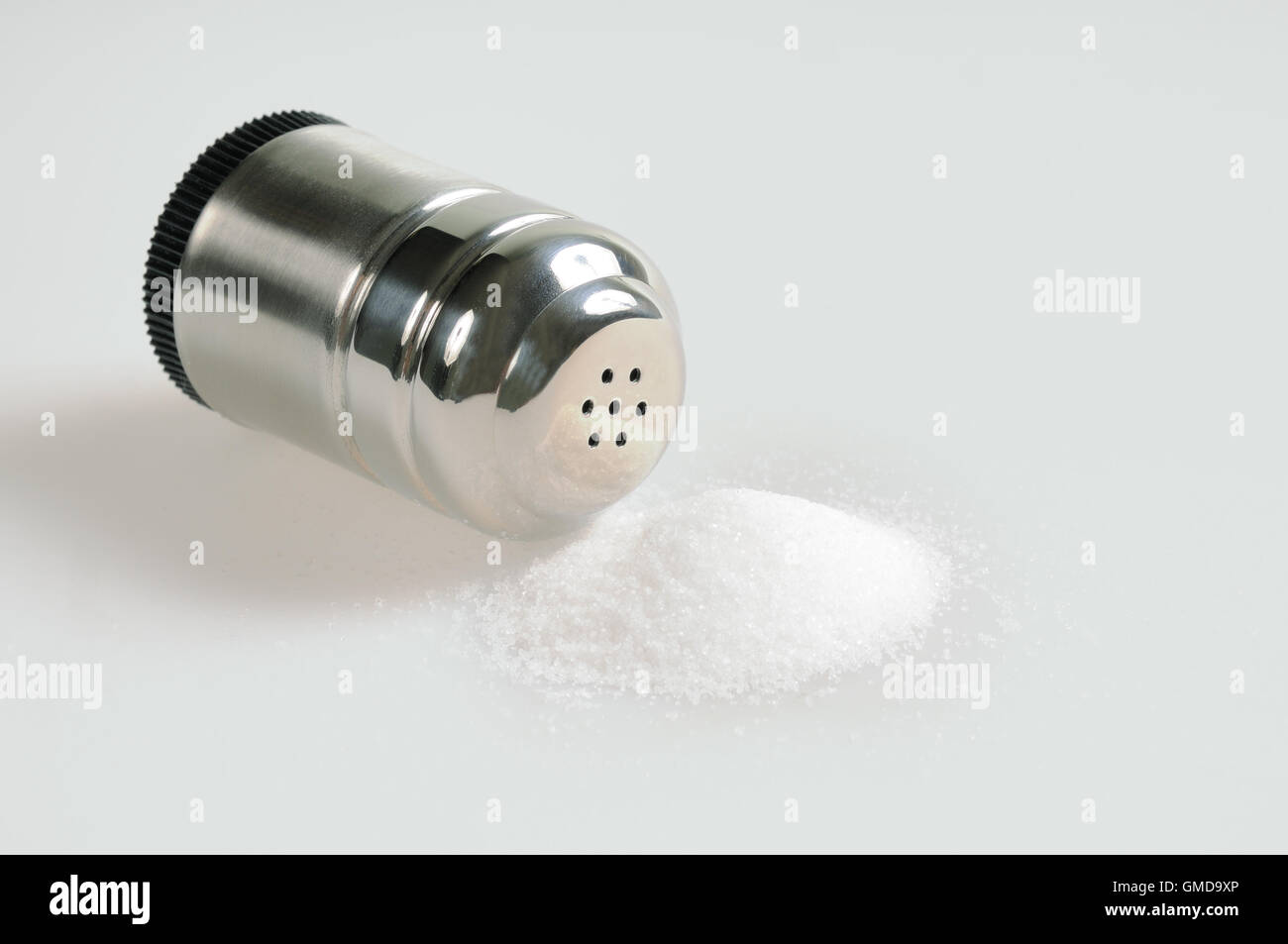 Salt shaker and spilled salt Stock Photo - Alamy