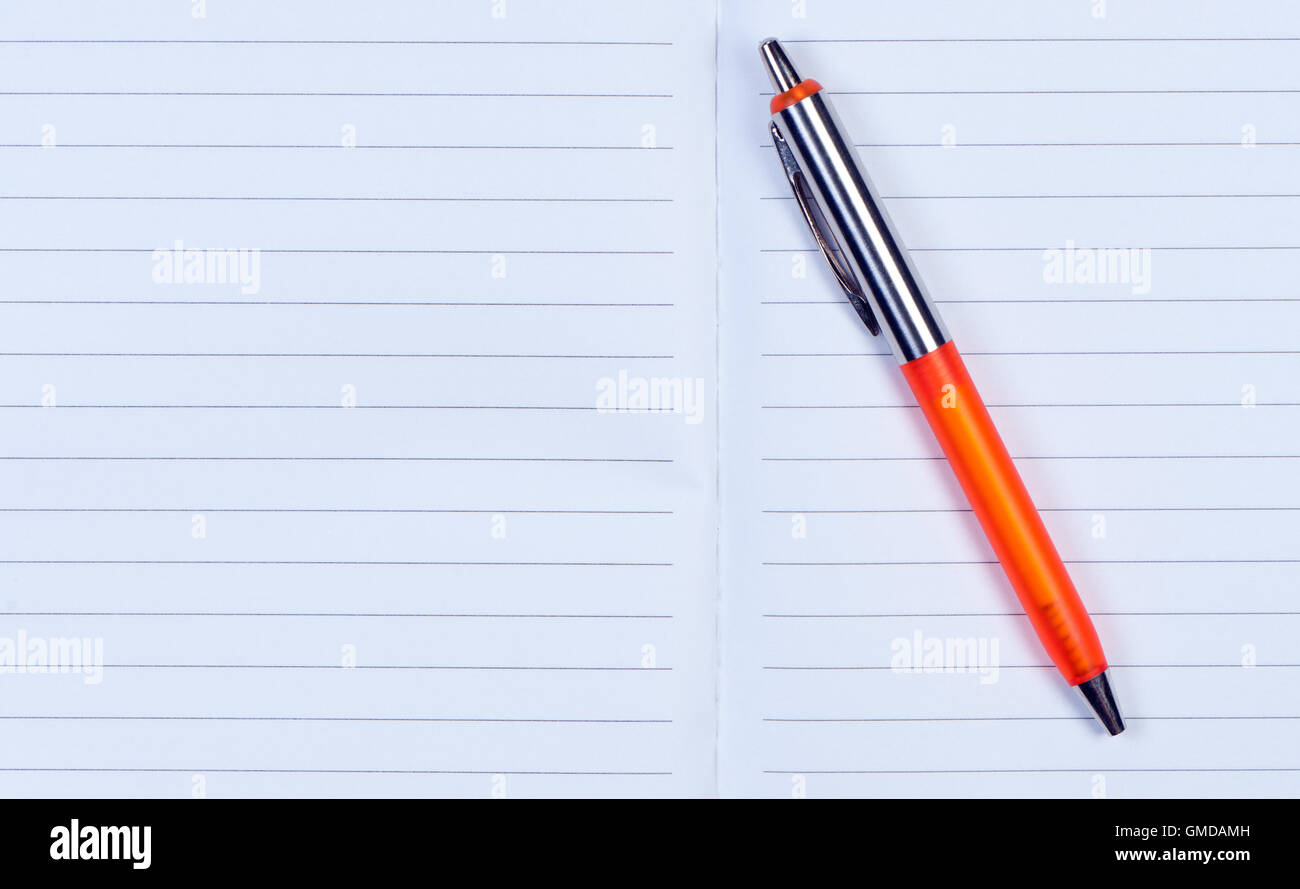 Pen on pages of notebook Stock Photo - Alamy