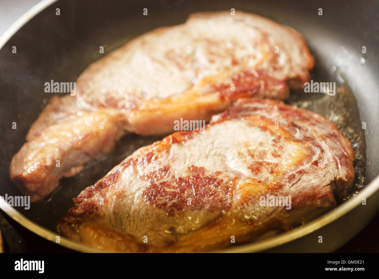 beef steak in a frying pan Stock Photo - Alamy