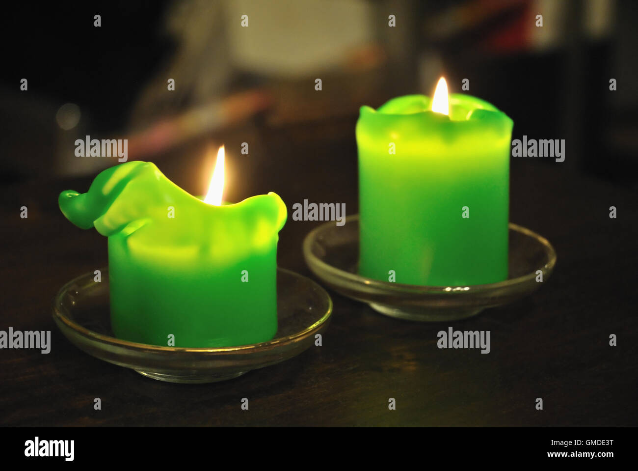 Molten green candle against a dark background Stock Photo - Alamy
