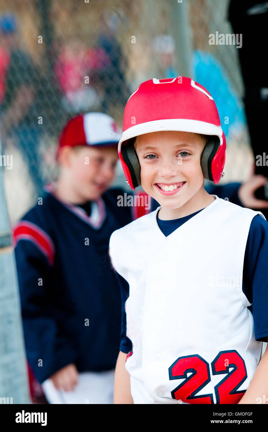 Little league baseball boy in dugout Stock Photo - Alamy