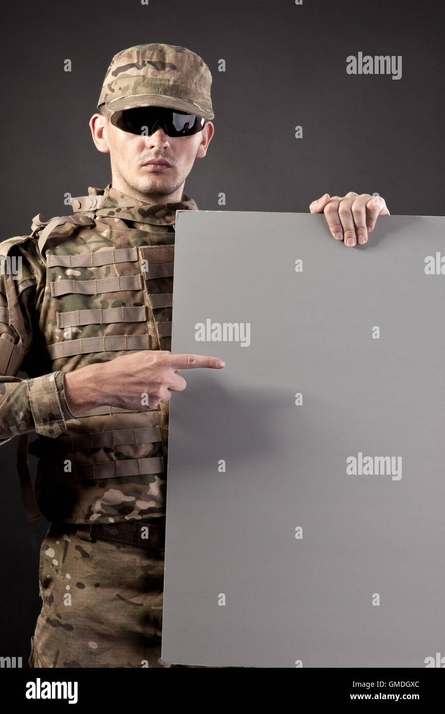 Modern soldier is holding a poster Stock Photo - Alamy