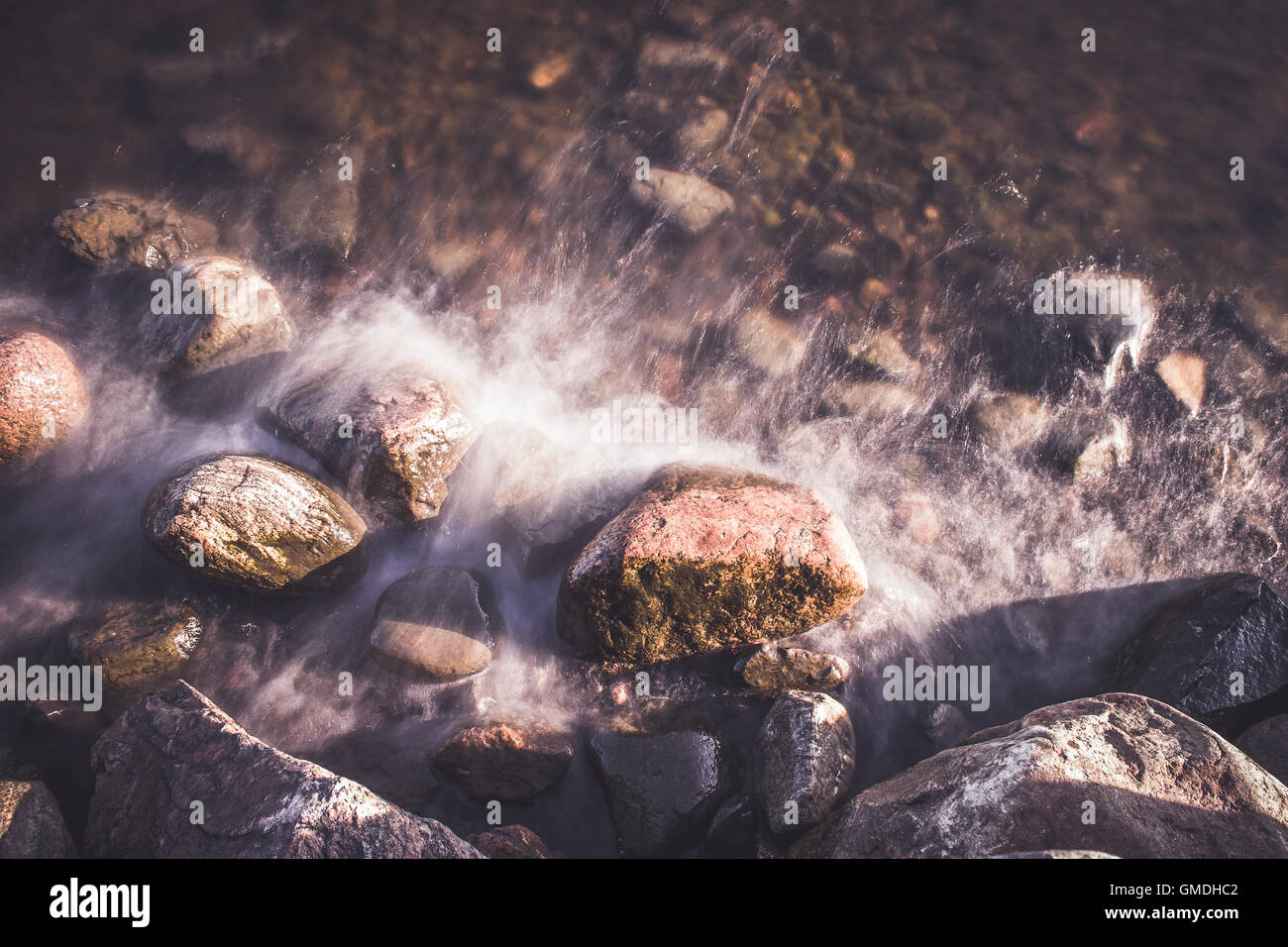Waves hitting rocks Stock Photo - Alamy
