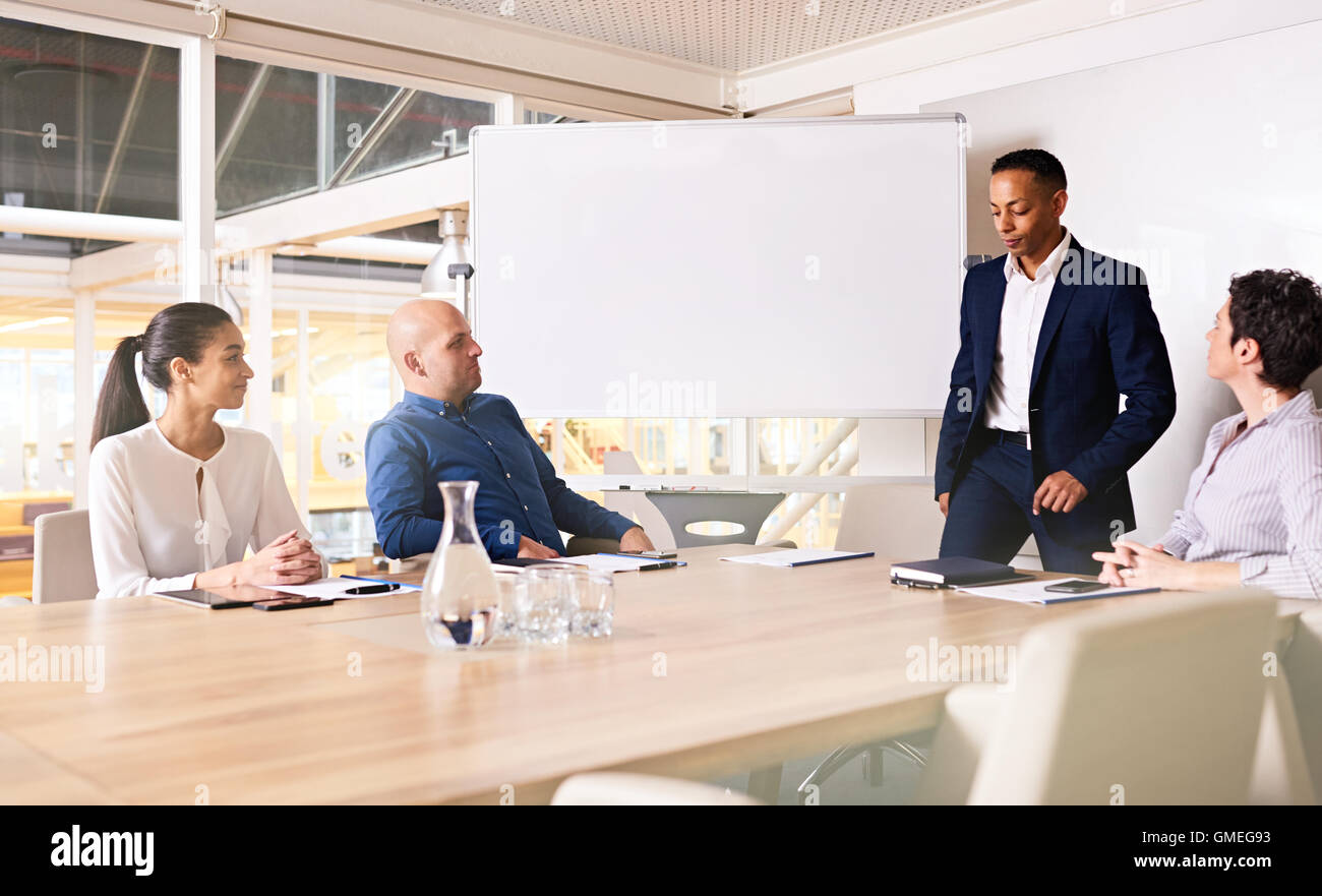 Chairman taking a seat at the board room table Stock Photo - Alamy