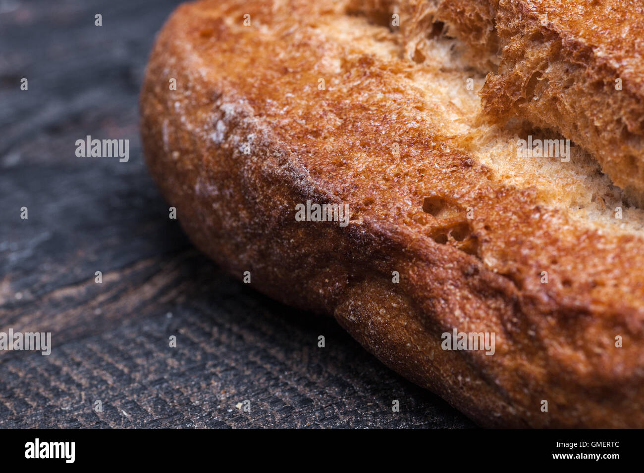 Rustic bread on wood table. Dark moody background with free text space ...