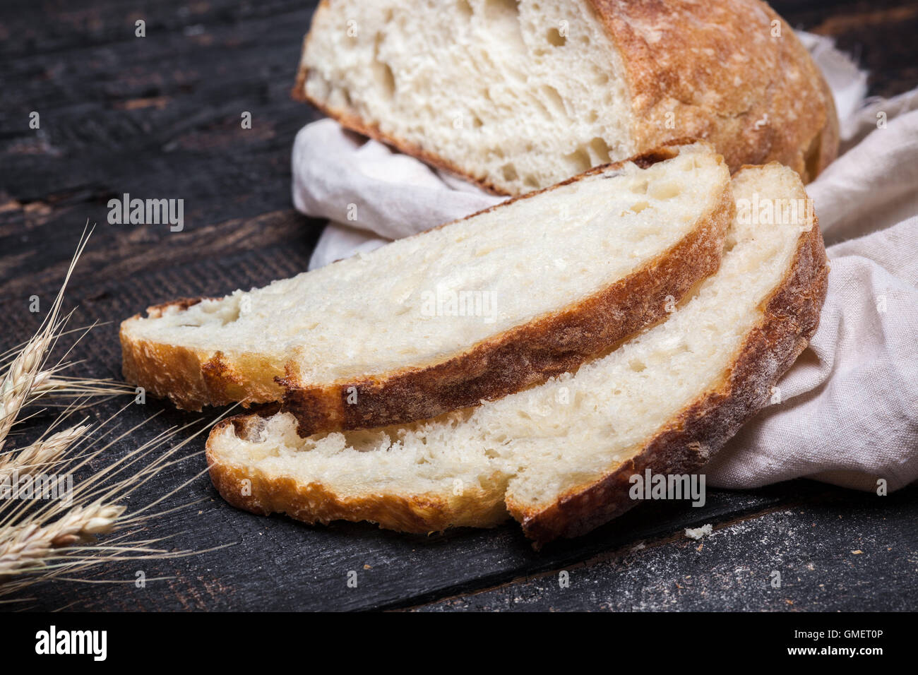 Rustic bread on wood table. Dark moody background with free text space ...