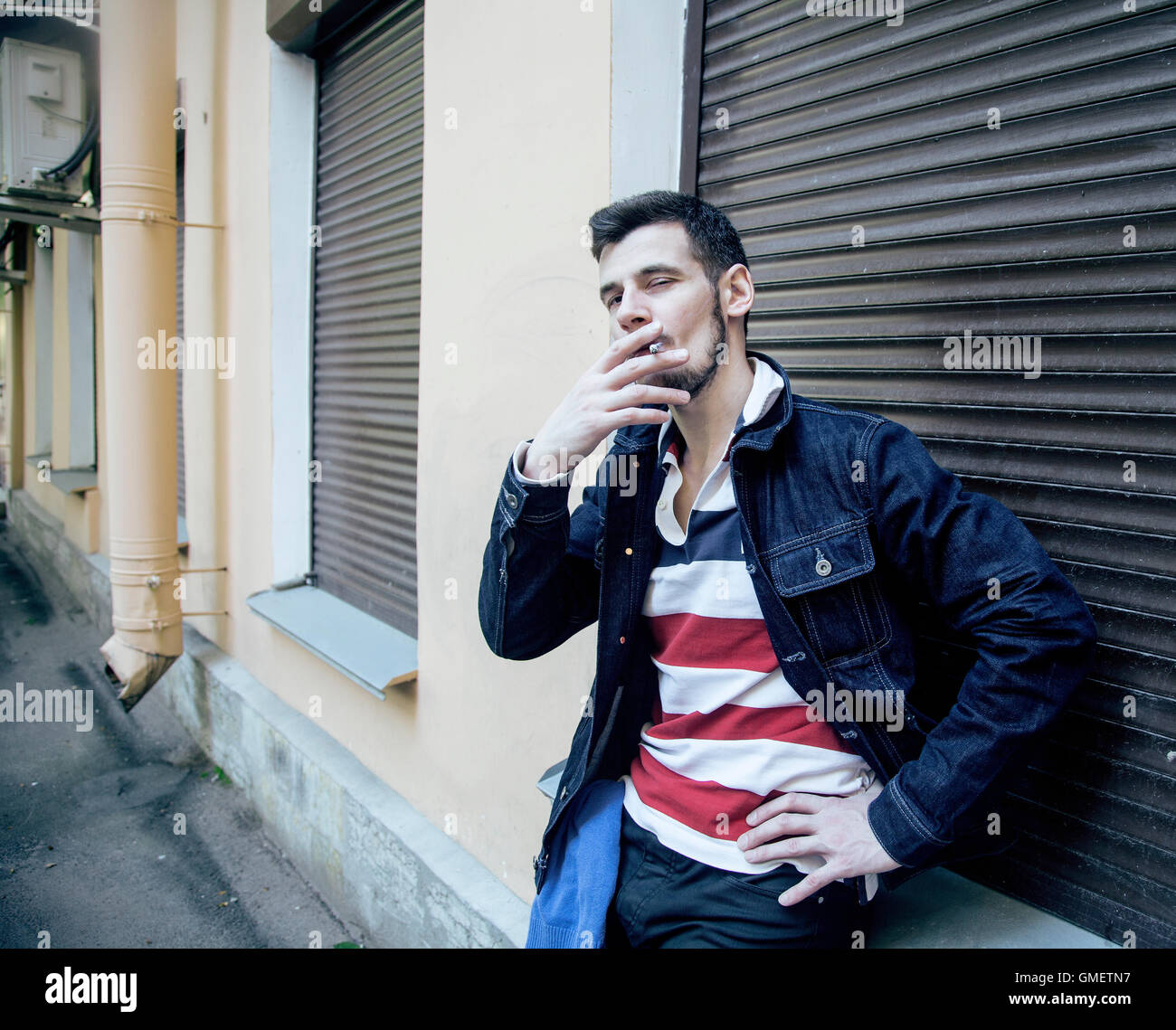 middle age man smoking cigarette on backjard, stylish tough guy ...