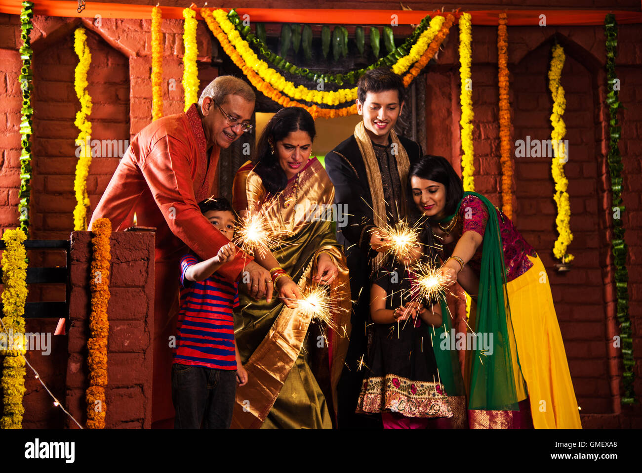 Indian Family celebrating Diwali festival with fire crackers Stock ...