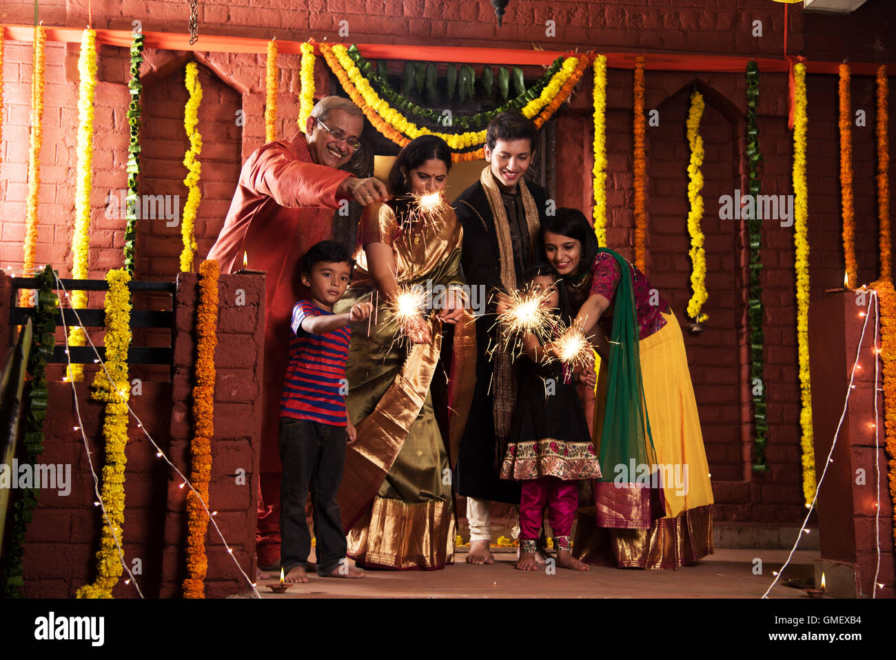 Indian Family celebrating Diwali festival with fire crackers Stock ...