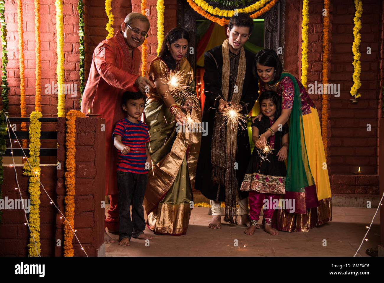 Indian Family celebrating Diwali festival with fire crackers Stock ...