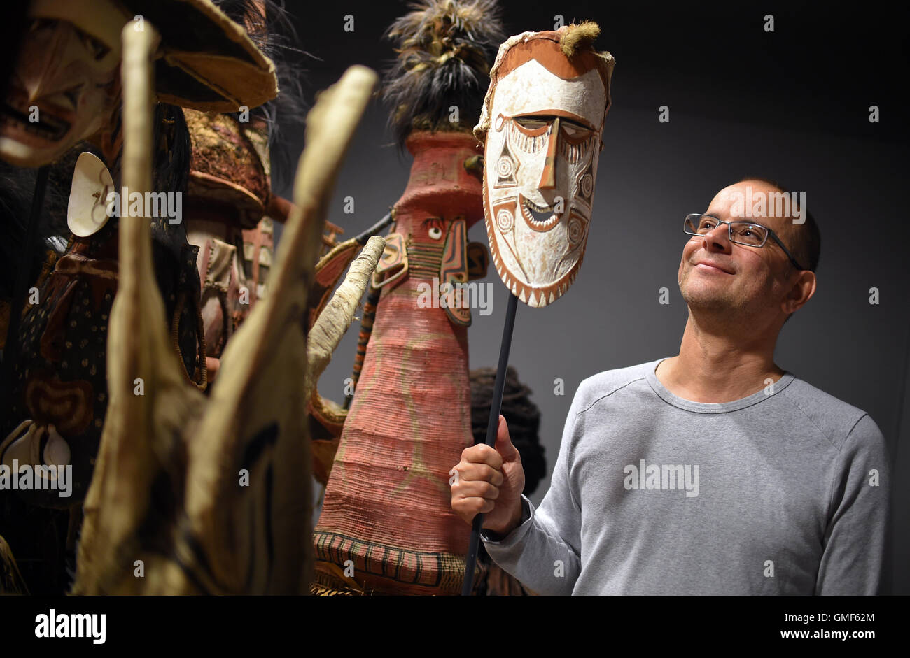 Depot manager Peter Jakob shows masks, ancestral poles and animal ...