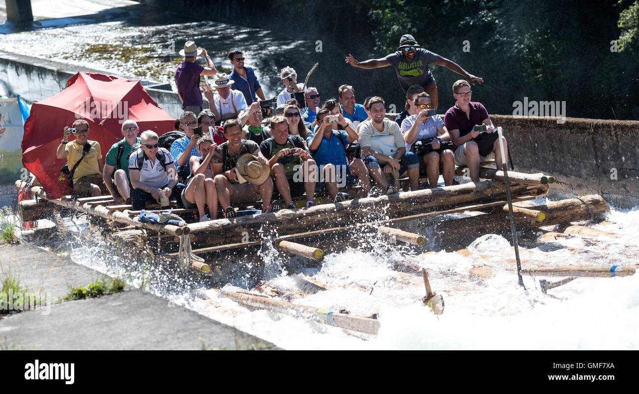 Excursionists ride in a raft down a chute near Strasslach, Germany, 24 ...