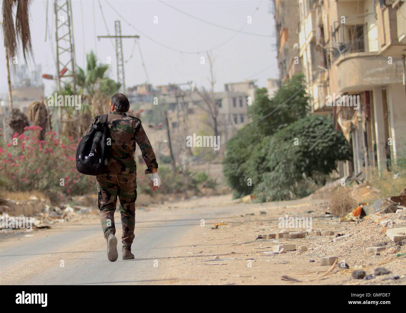 Daraya, Syria. 26th Aug, 2016. A Syrian soldier walks in the town of ...