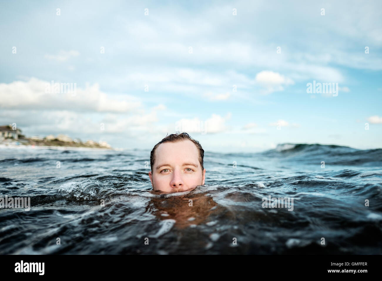 Portrait of young man in water with half of his face showing Stock ...