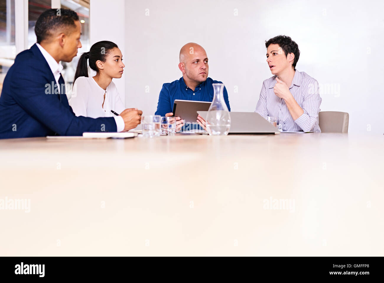 authentic group of business people sitting at a conference table Stock ...