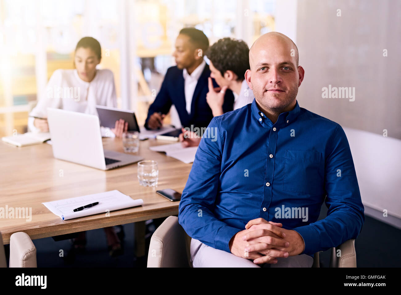 leader looking at the camera in front of his team Stock Photo - Alamy