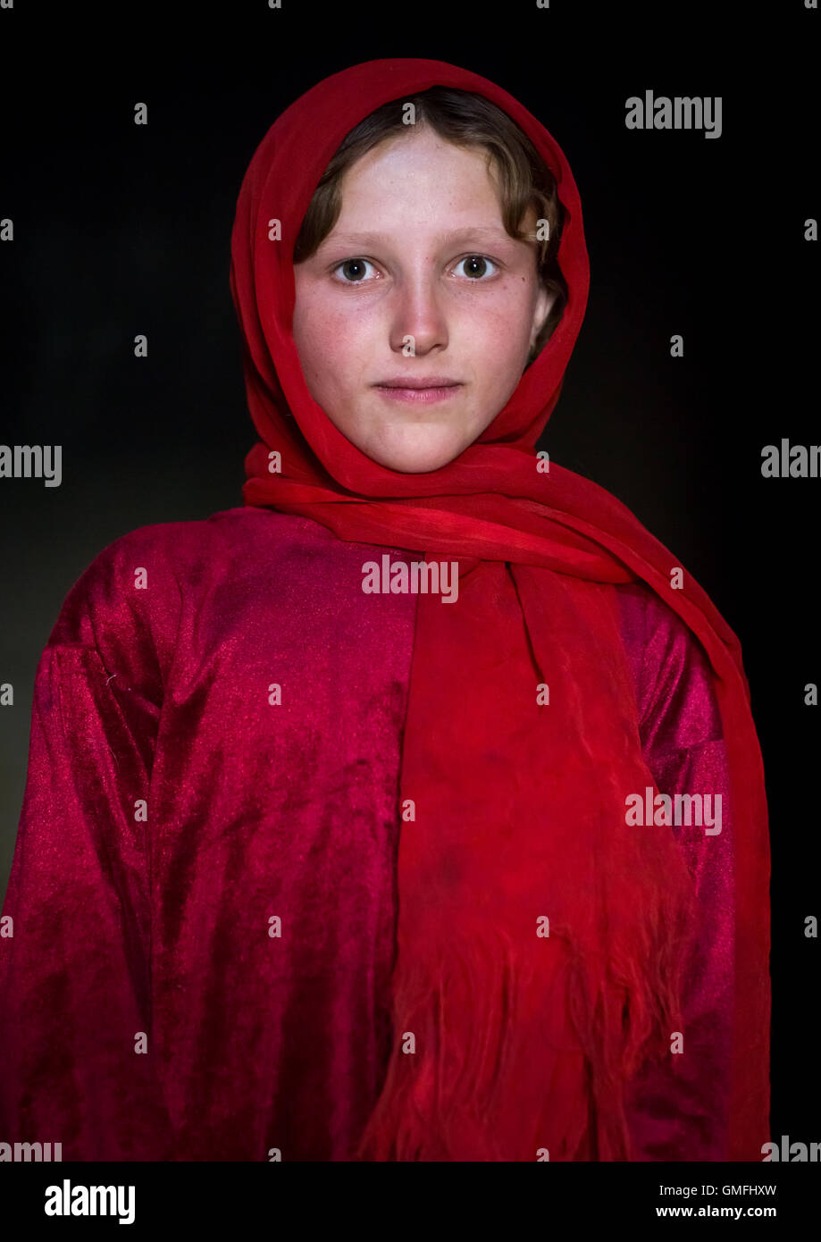 Portrait of an afghan girl with pale skin wearing red clothes ...