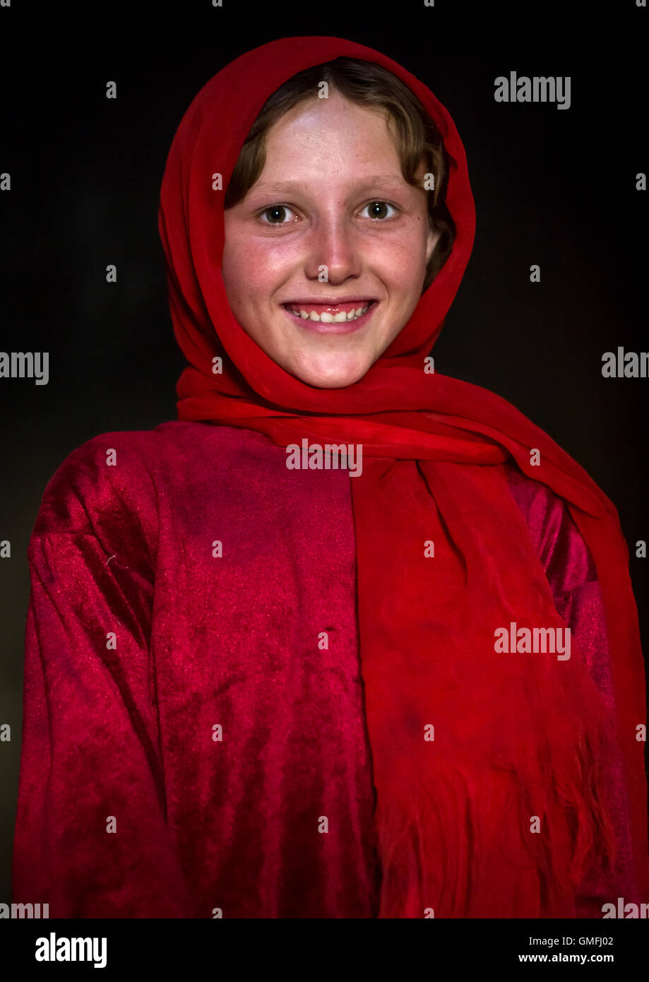 Portrait of an afghan girl with pale skin wearing red clothes ...