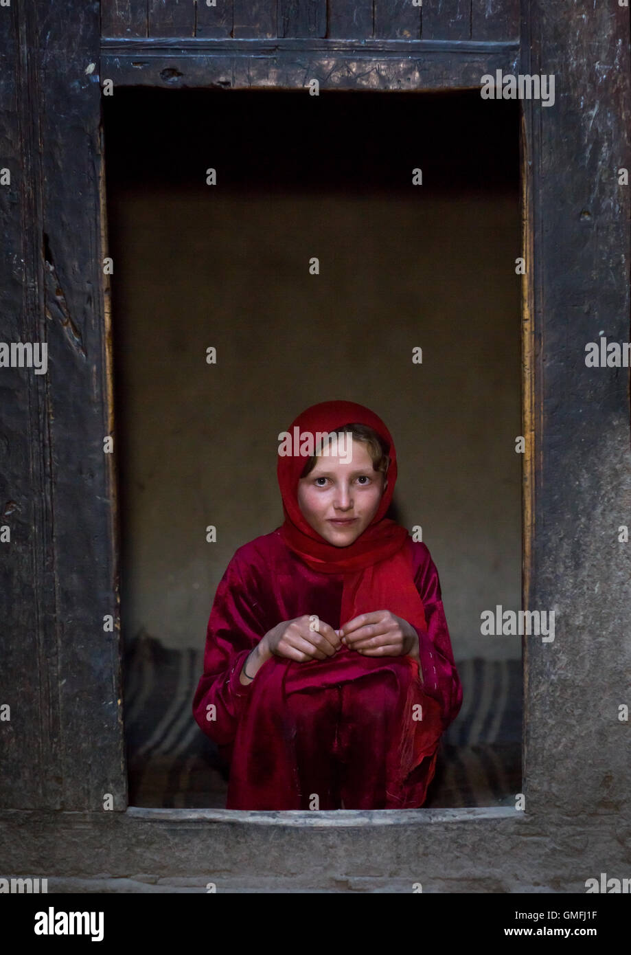 Portrait of an afghan girl with pale skin wearing red clothes ...