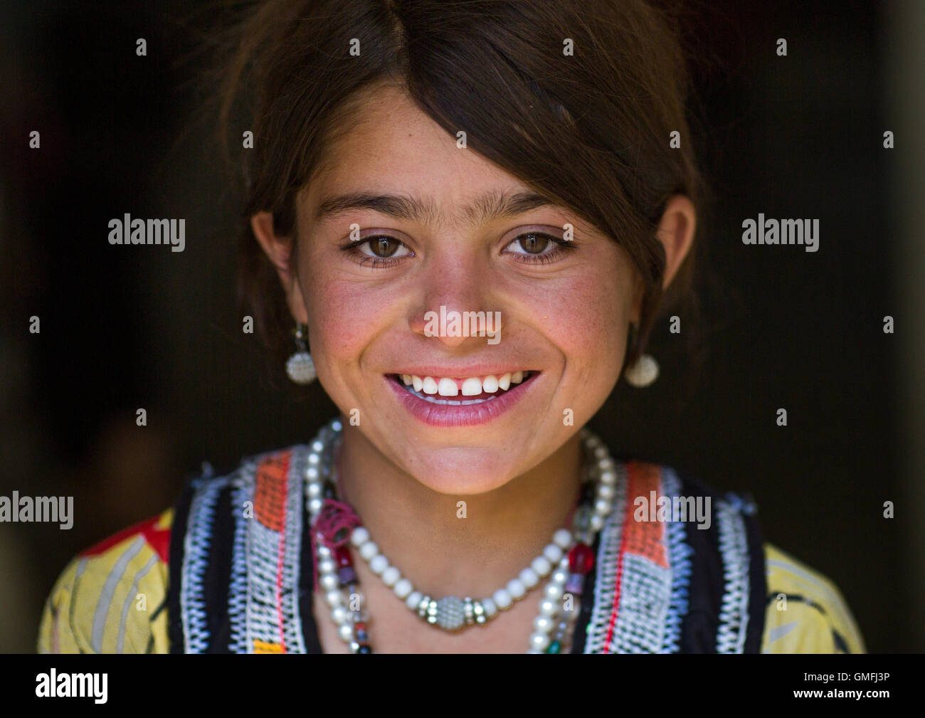 Smiling afghan girl in traditional clothing, Badakhshan province, Wuzed ...