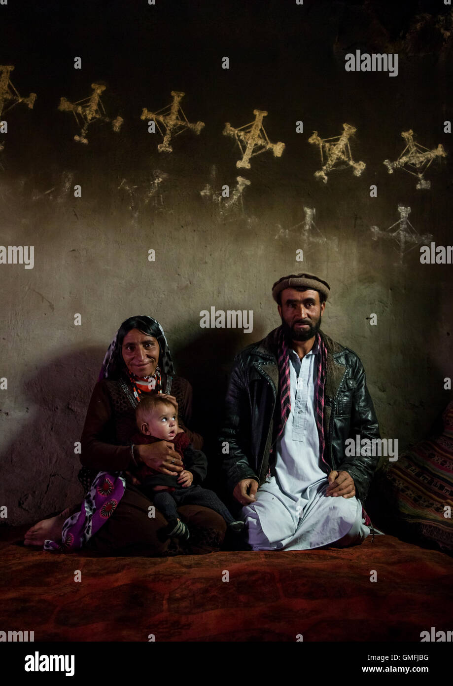 Afghan family inside their traditional pamiri house with the walls ...