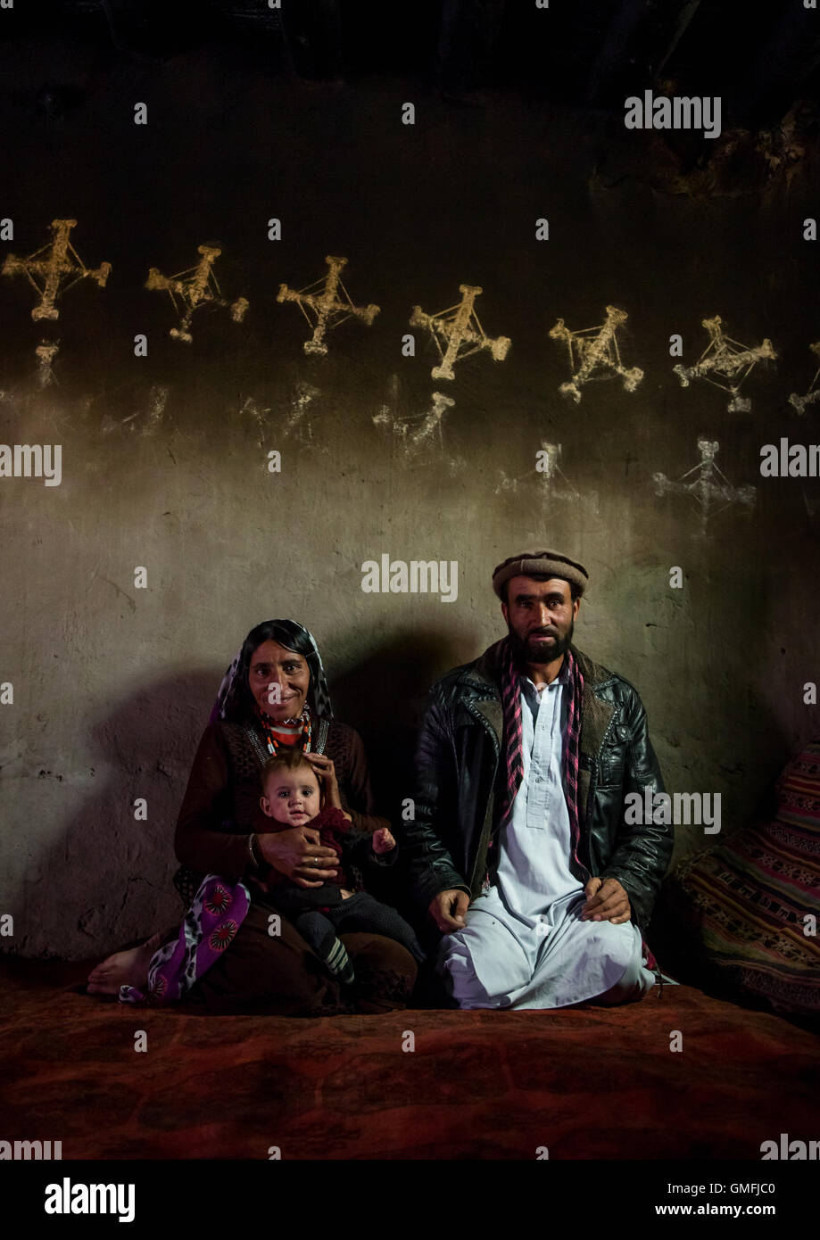 Afghan family inside their traditional pamiri house with the walls ...