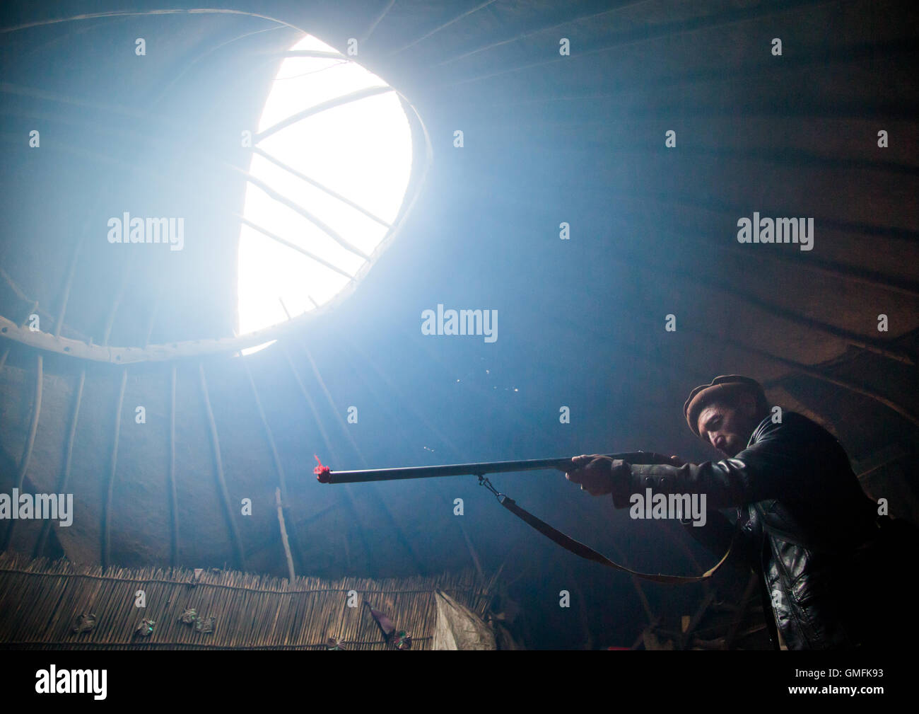 Wakhi nomad man with his gun inside his yurt, Big pamir, Wakhan ...