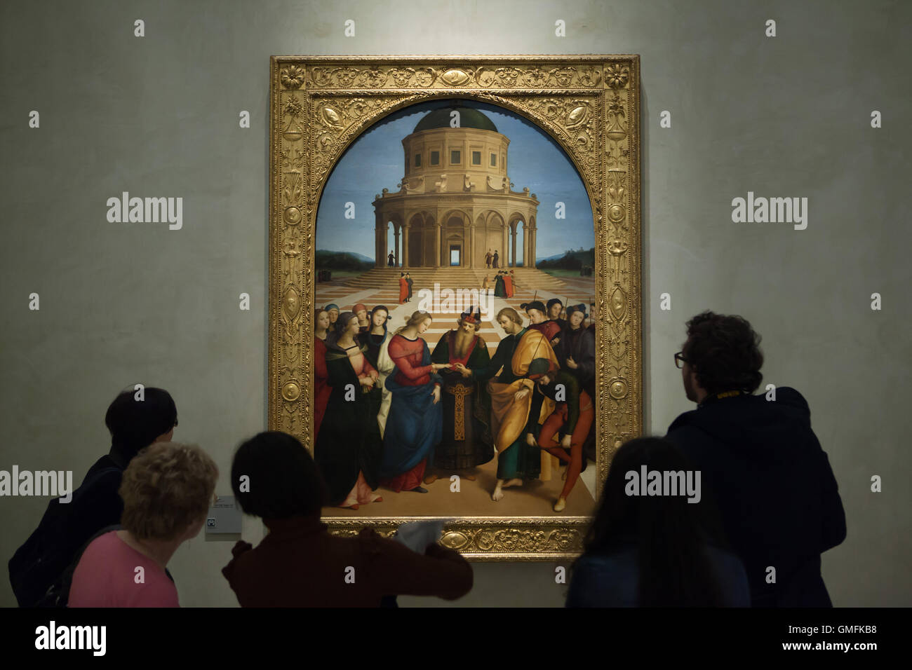 Visitors in front of the painting 'Marriage of the Virgin', also known ...