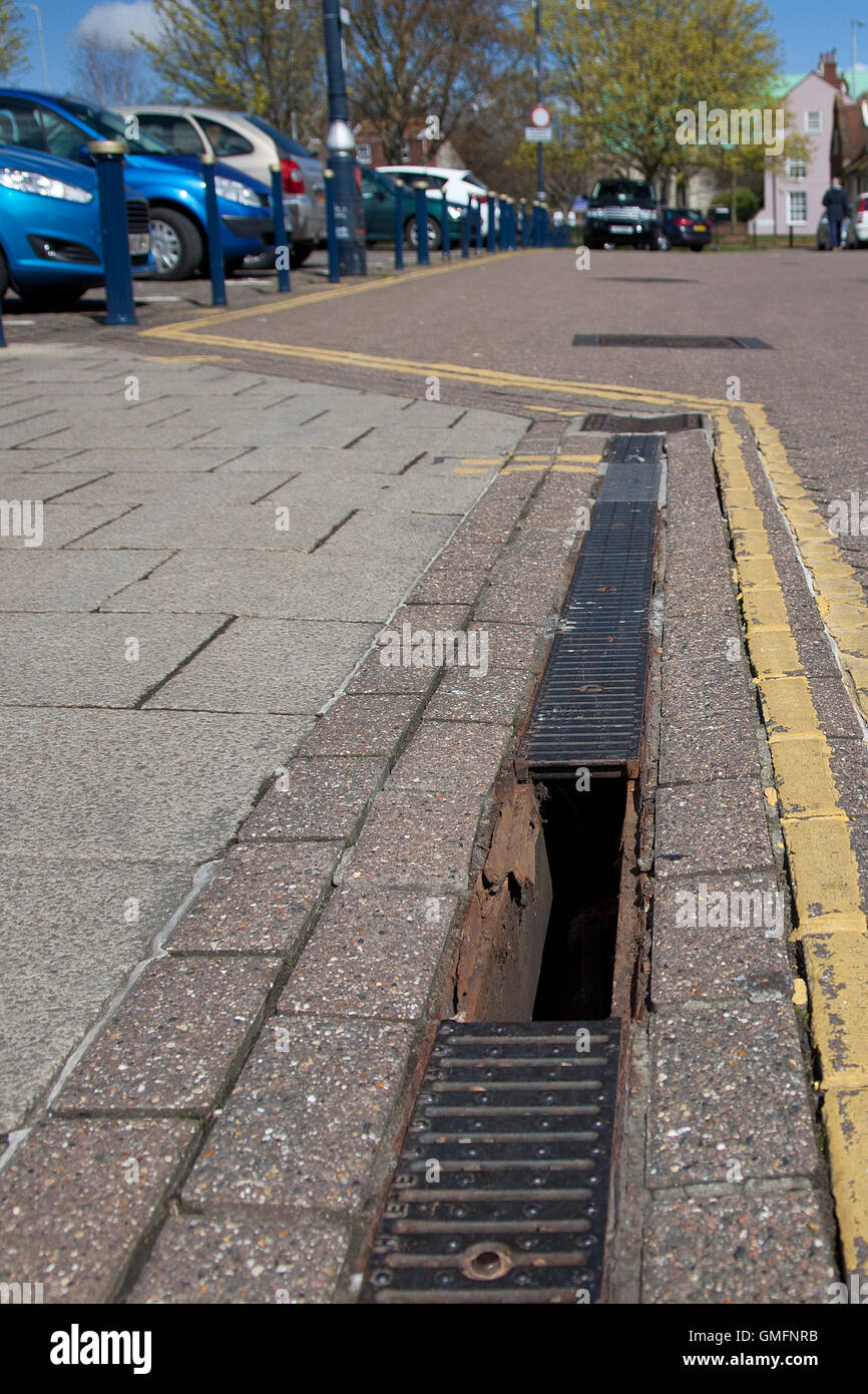Missing grate cover on a pedestrianised street in Great Yarmouth posing ...
